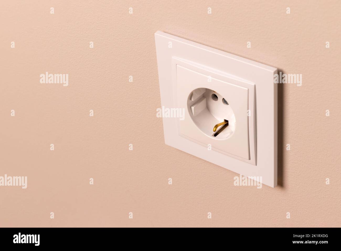 White european electrical outlet on modern beige wall Stock Photo - Alamy