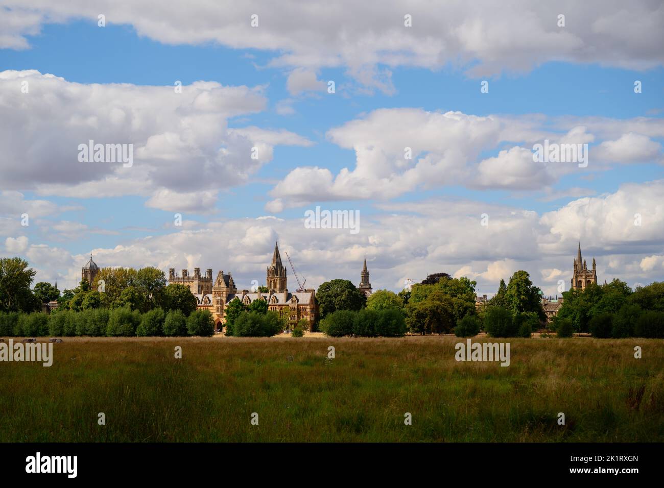 A scenic view of the meadow of the Christ Church with a cloudy sky in ...