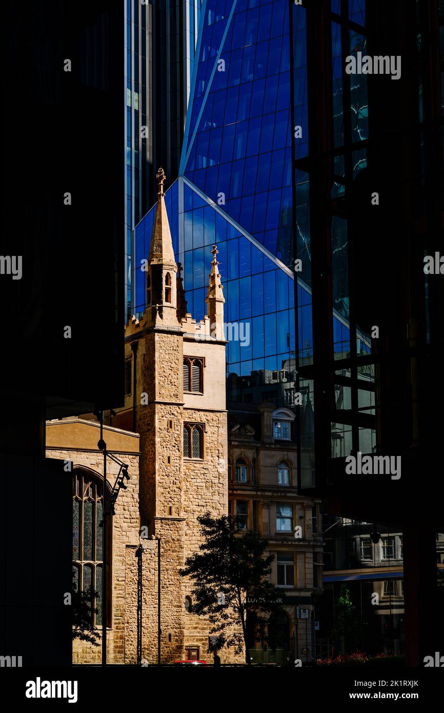 A church and its reflection on the windows of a skyscraper exposed to ...