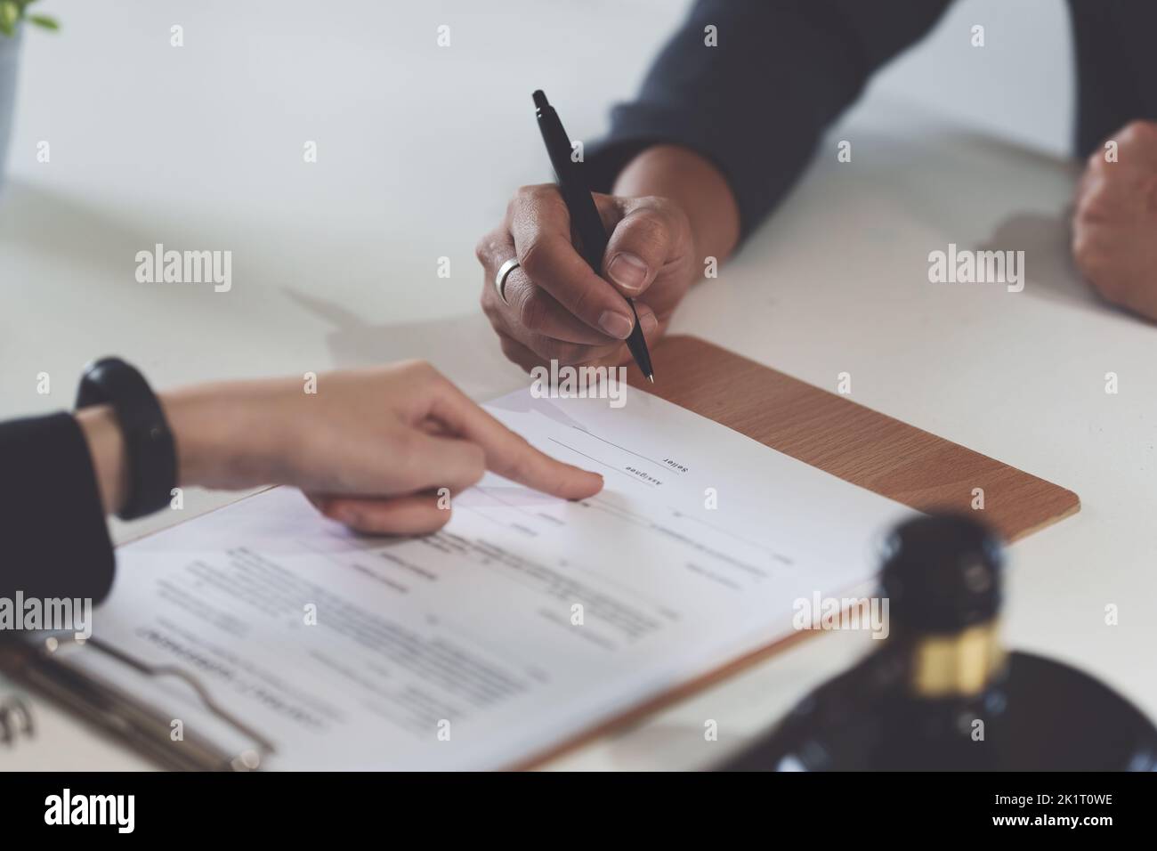 Business woman and lawyers discussing contract papers with brass scale ...