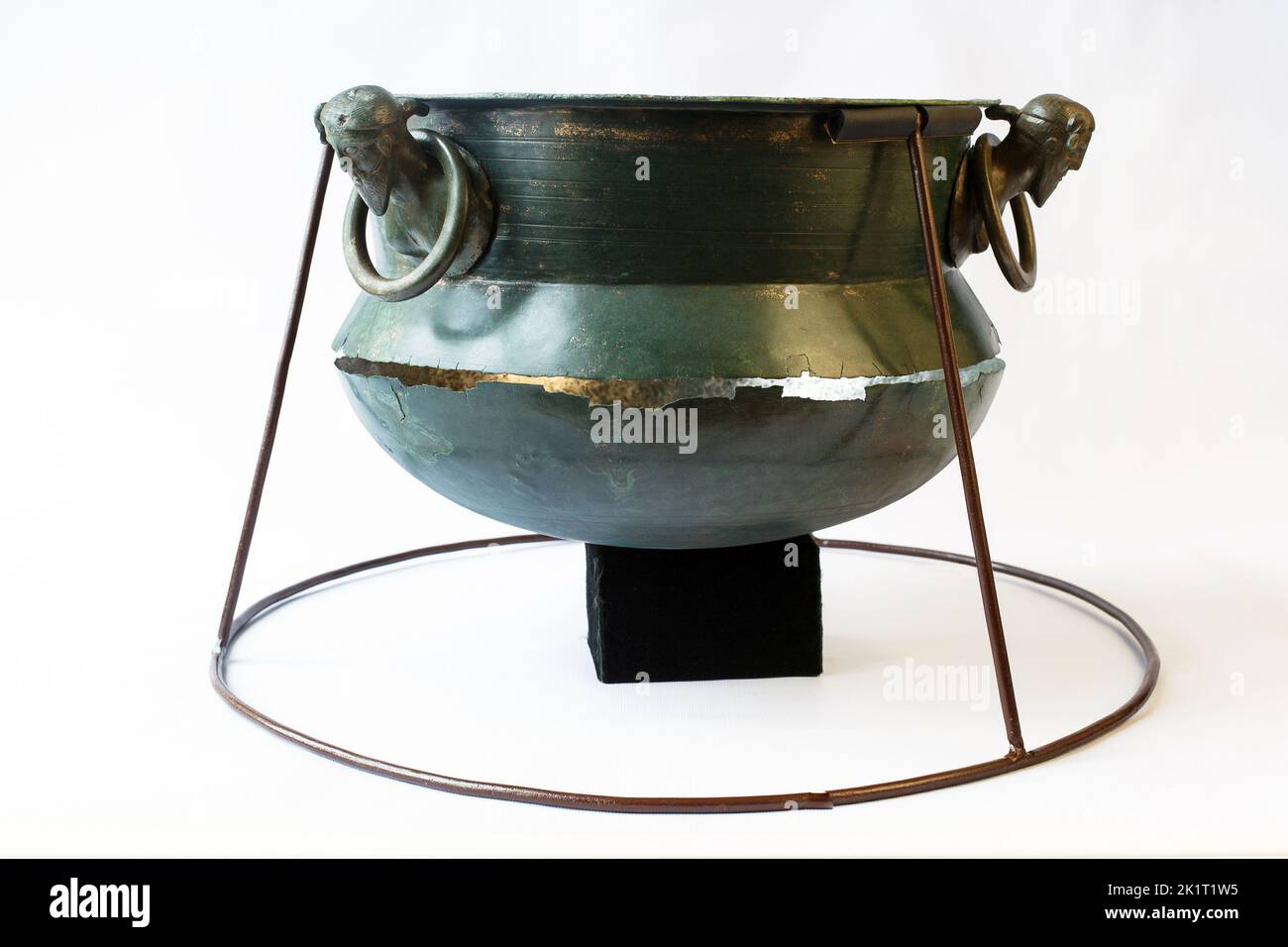The cauldron is decorated by four cast heads of Germanic men wearing a ...