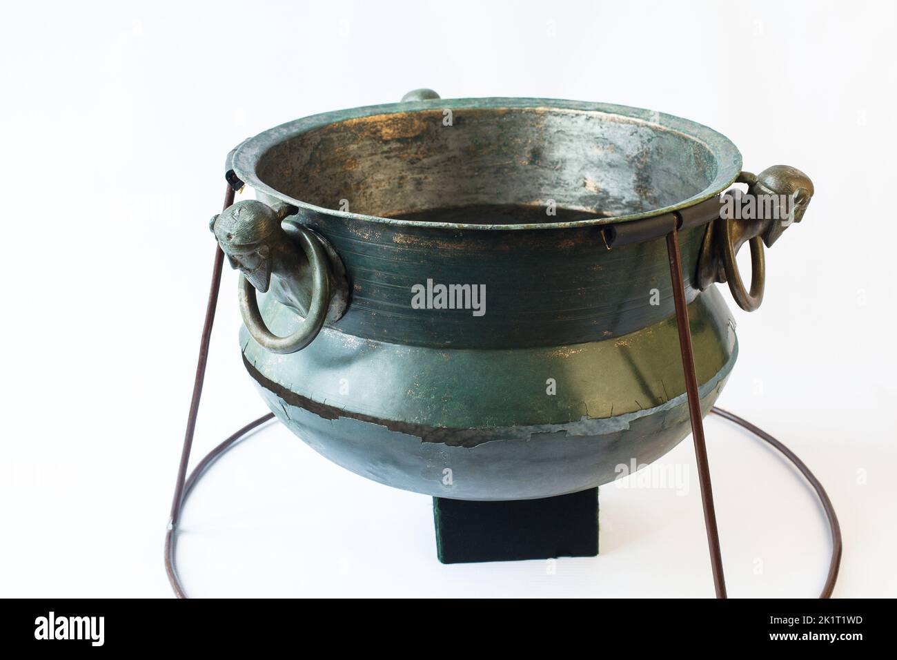 The cauldron is decorated by four cast heads of Germanic men wearing a ...