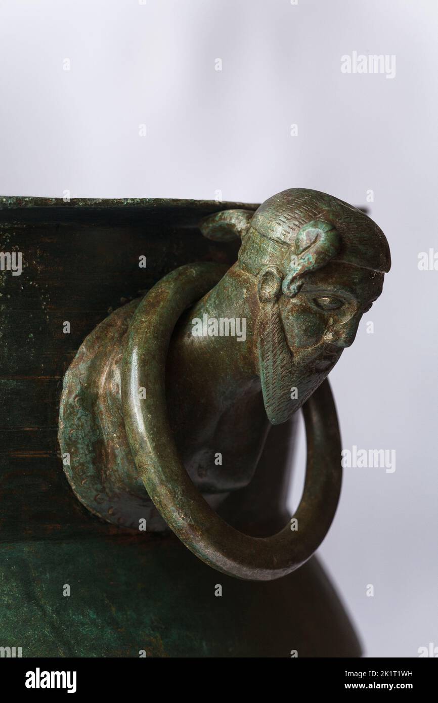 The cauldron is decorated by four cast heads of Germanic men wearing a ...