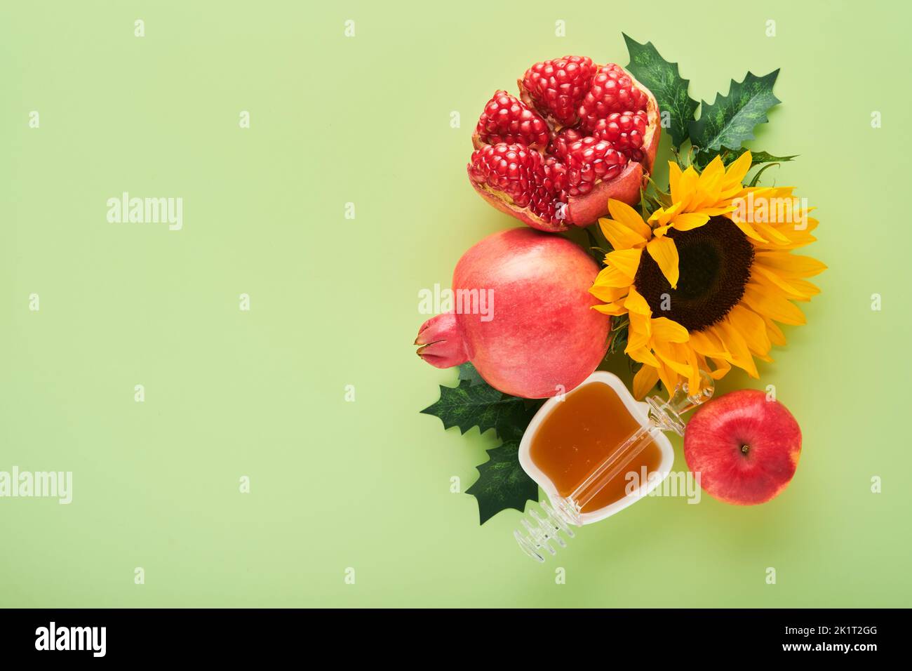 Rosh Hashanah. Ripe pomegranate, apple, honey and sunflower, yellow ...
