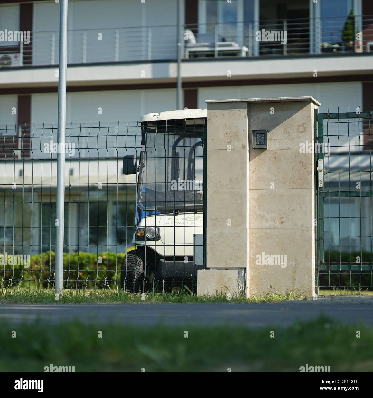 Modern building with hotel cart parking at the fence Stock Photo - Alamy