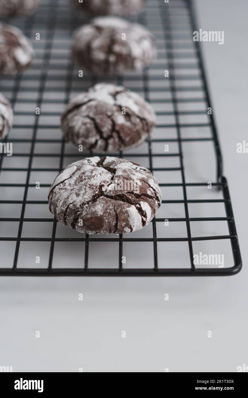 Chocolate Crinkle iced biscuits arranged on a white marble kitchen work ...