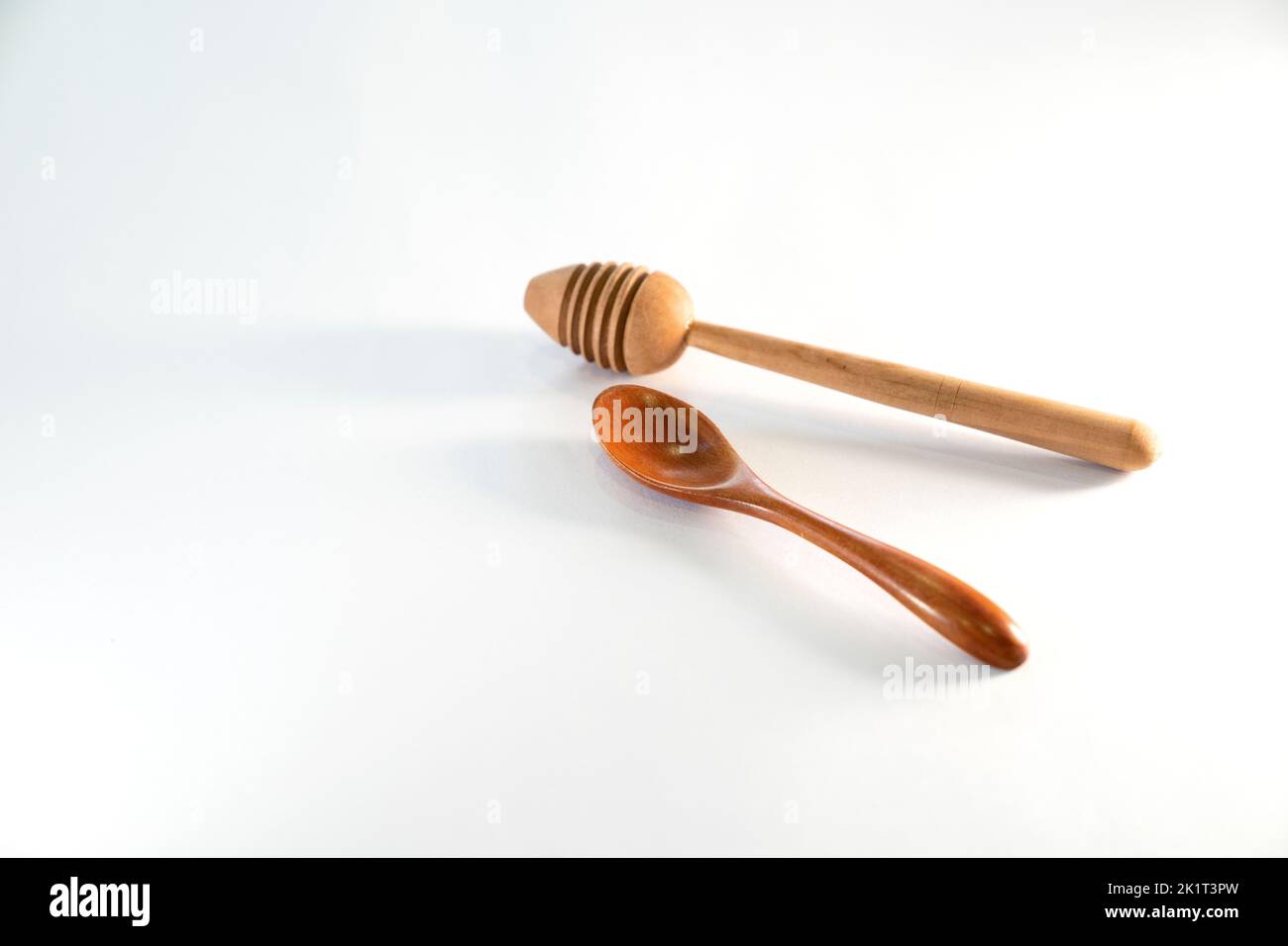 Wooden spoon and honey dipper on isolated white background Stock Photo ...