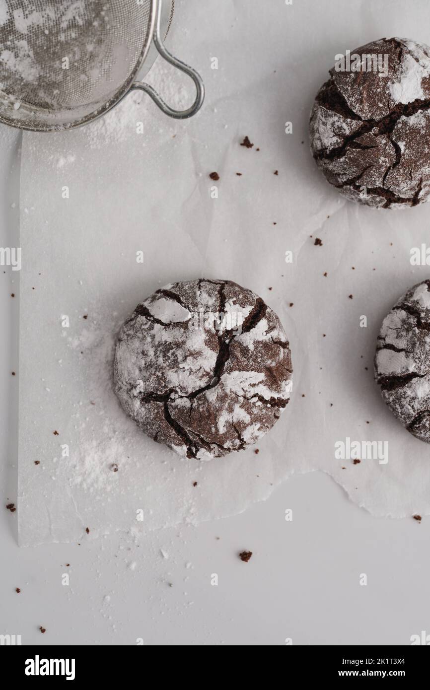 Chocolate Crinkle iced biscuits arranged on a white marble kitchen work ...