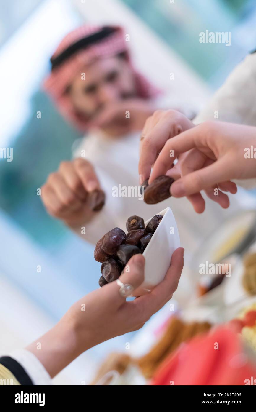 modern multiethnic muslim family sharing a bowl of dates while enjoying ...