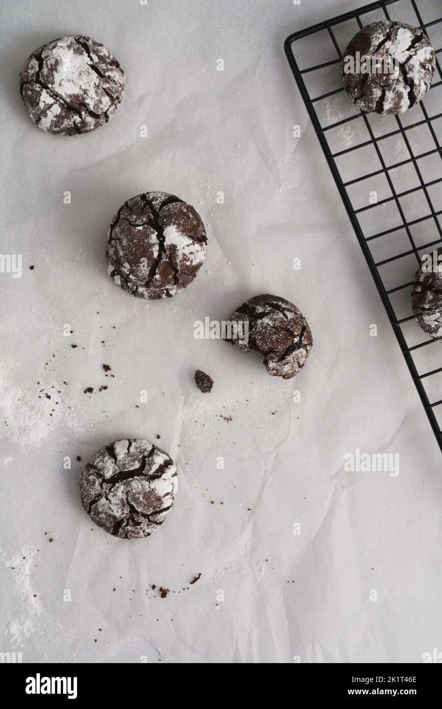 Chocolate Crinkle iced biscuits arranged on a white marble kitchen work ...