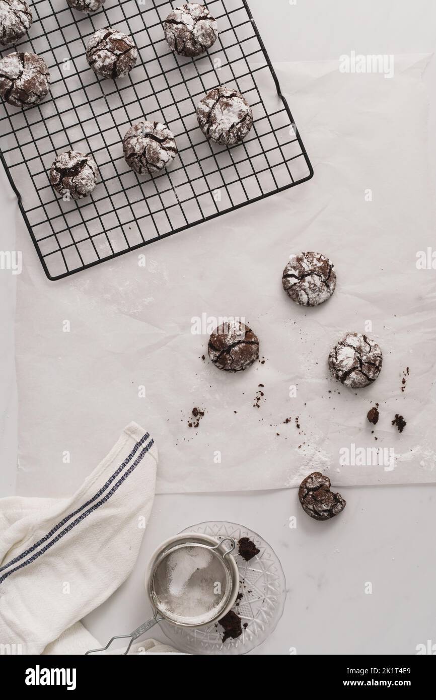 Chocolate Crinkle iced biscuits arranged on a white marble kitchen work ...
