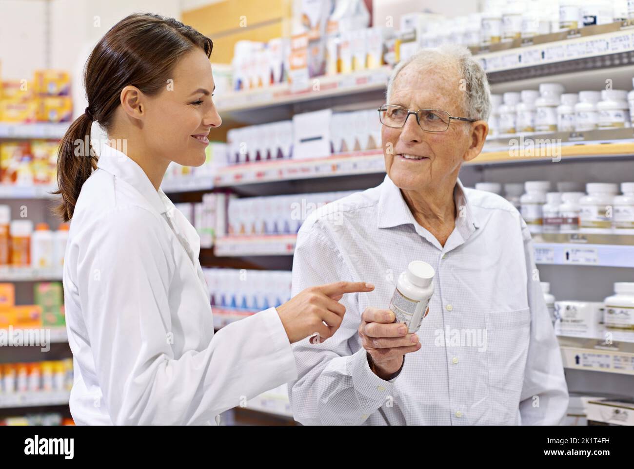 This is exactly what you need. a young pharmacist helping an elderly ...