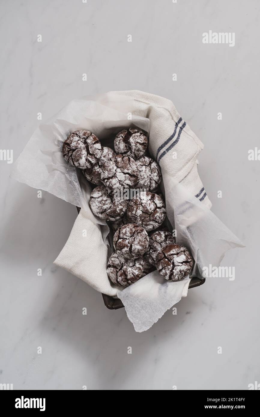 Chocolate Crinkle iced biscuits arranged on a white marble kitchen work ...