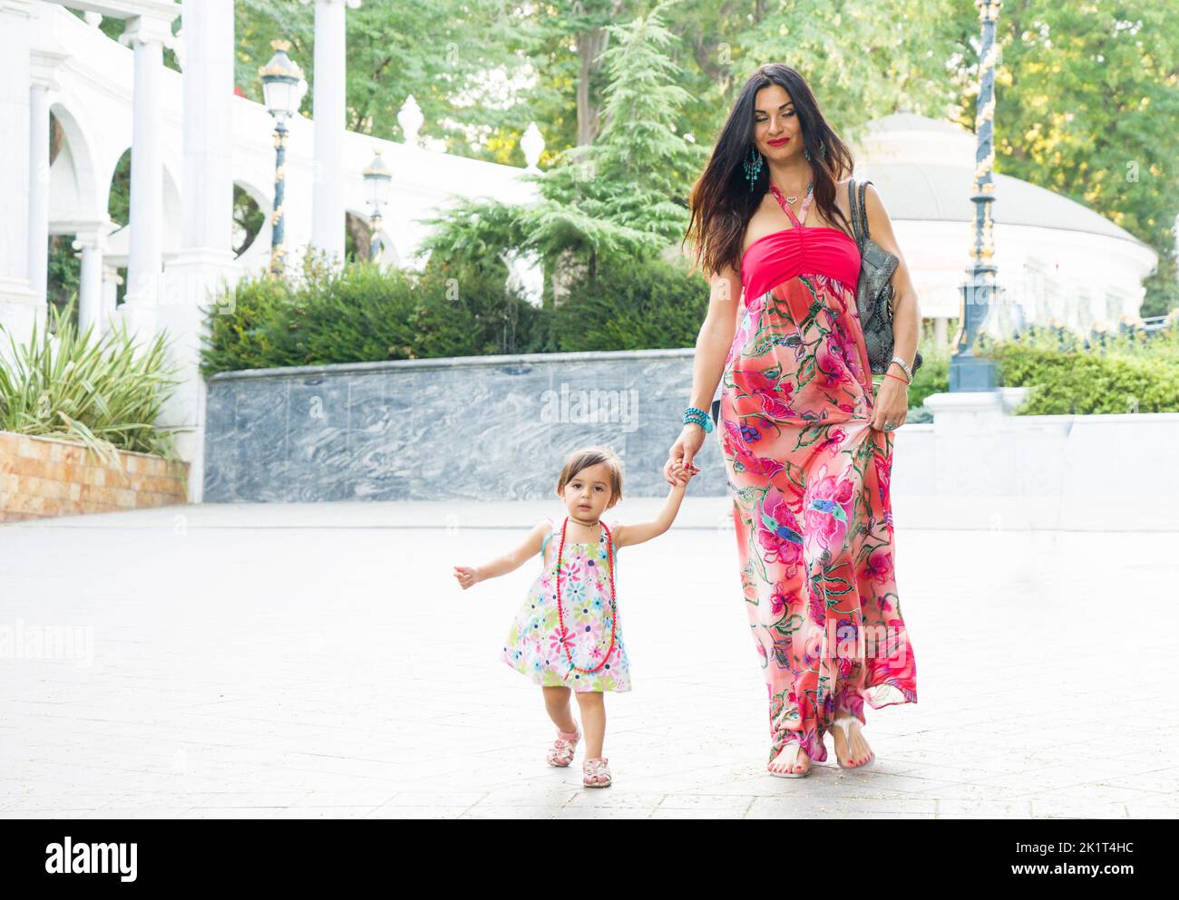 mother and daughter walking holding their hands in park Stock Photo - Alamy