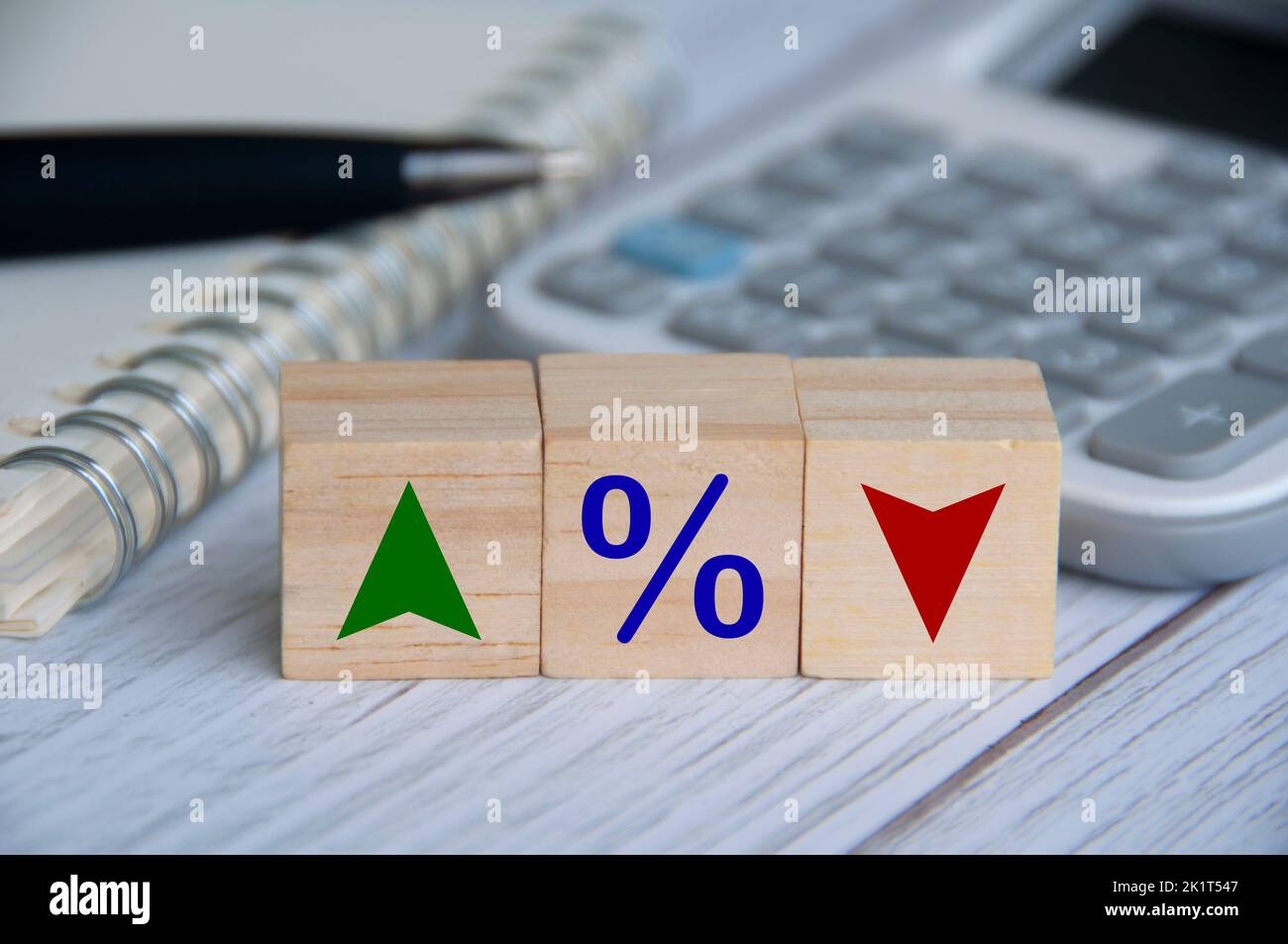 Wooden blocks with icon percentage and symbol arrow up and down ...