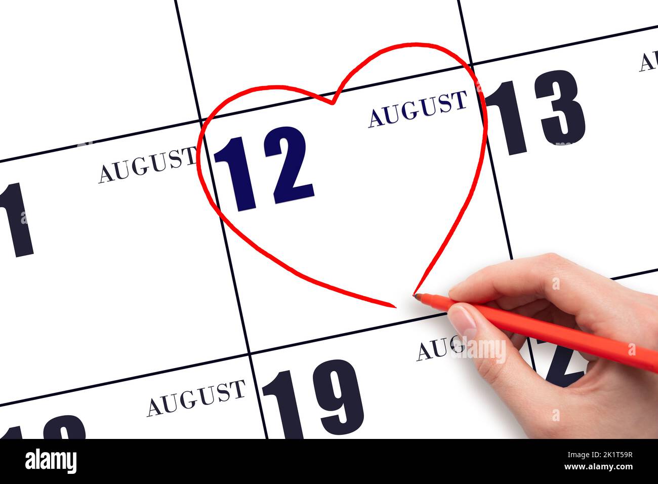 12th day of August. A woman's hand drawing a red heart shape on the ...