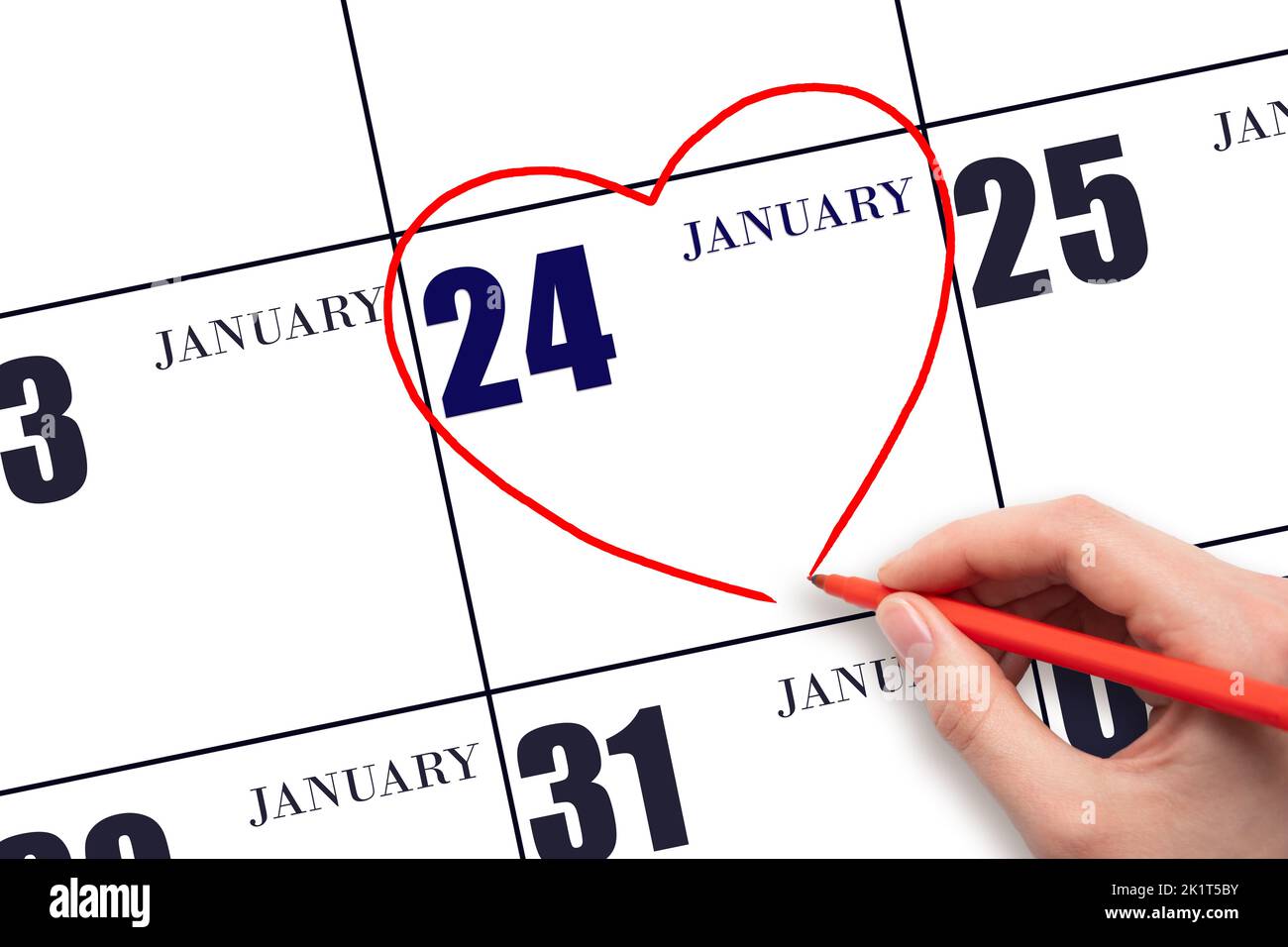 24th day of January. A woman's hand drawing a red heart shape on the ...