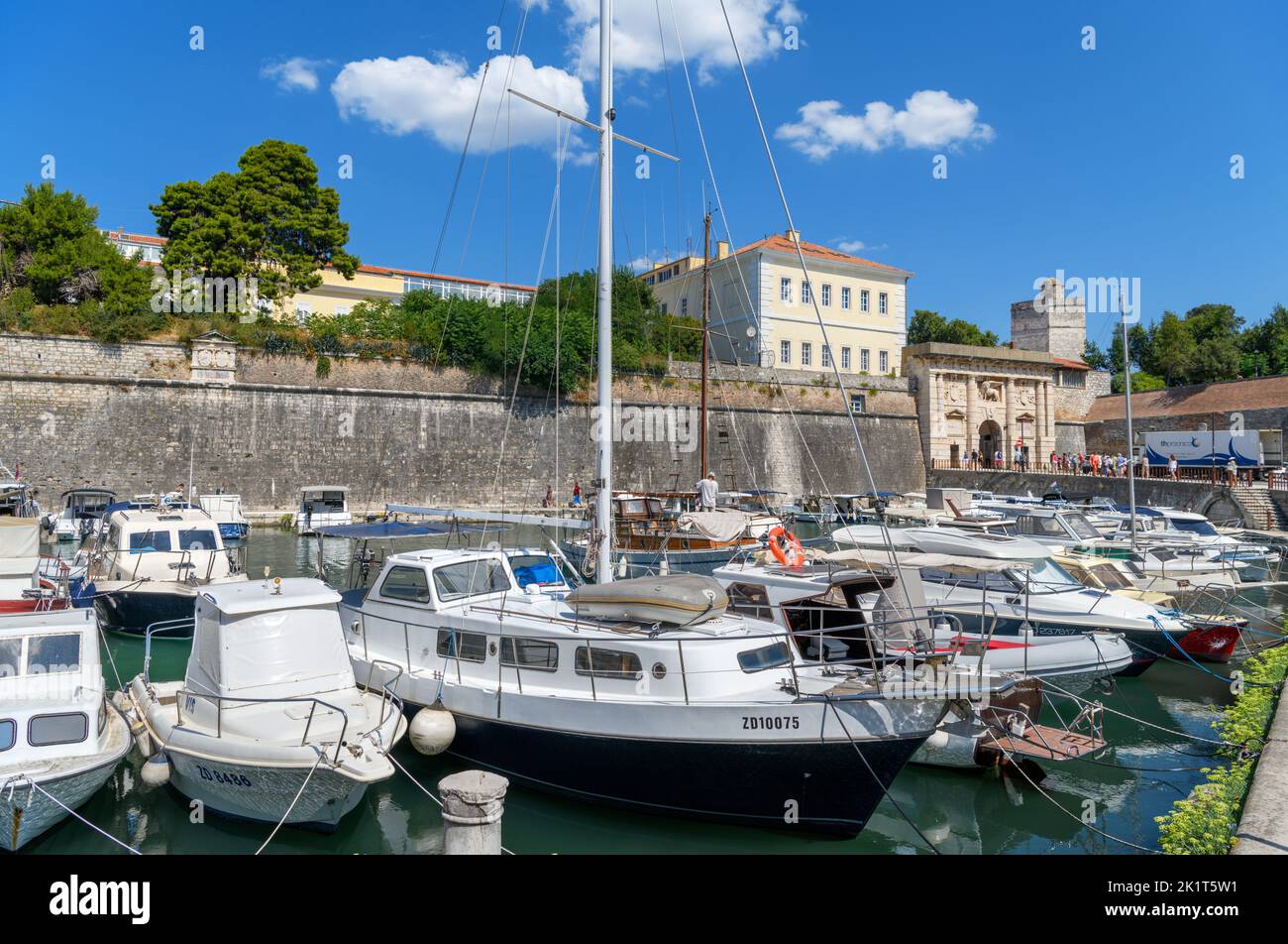 Boats moored in front of the Land Gate, historic entrance to the city ...