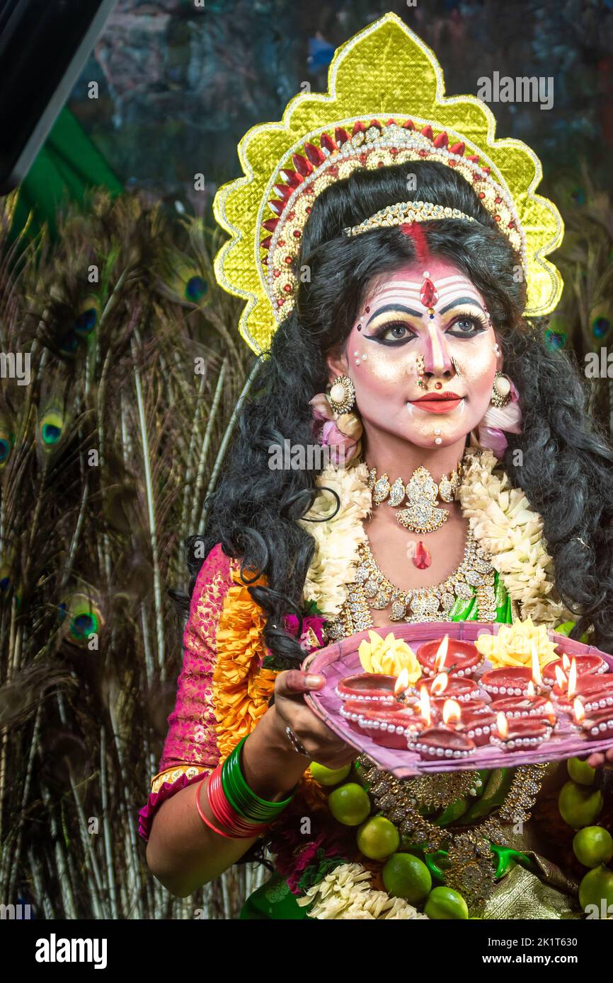 Concept Agomoni shoot with black haired Indian brunette woman face with ...