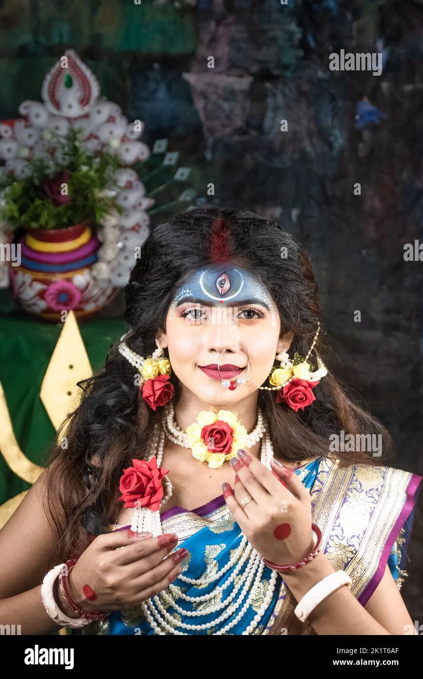 Concept Agomoni shoot with black haired Indian brunette woman face with ...