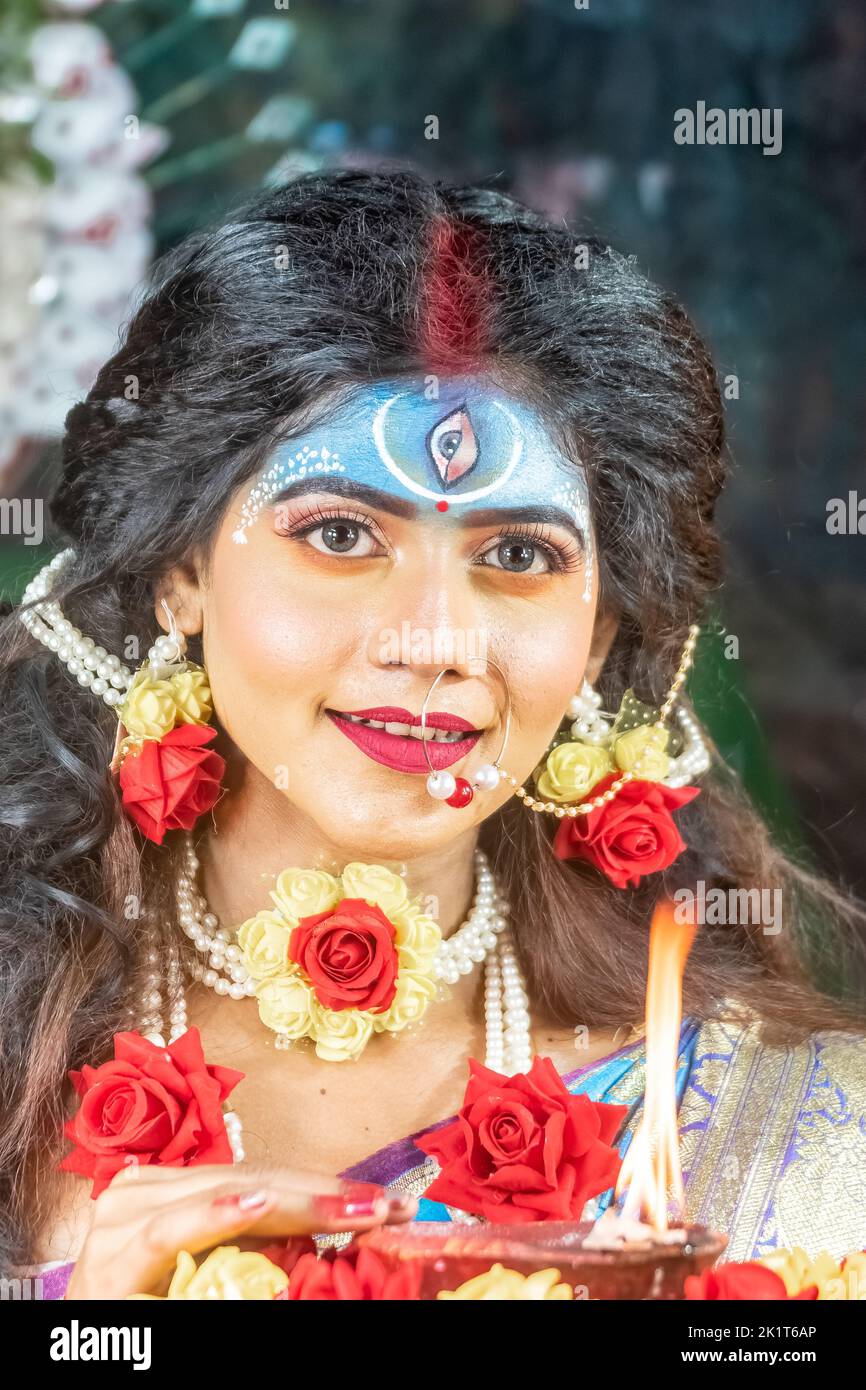 Concept Agomoni shoot with black haired Indian brunette woman face with ...