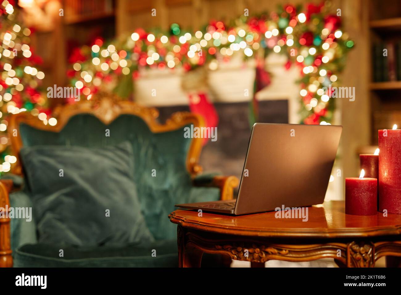 Background image of opened laptop on wooden table with candles in ...