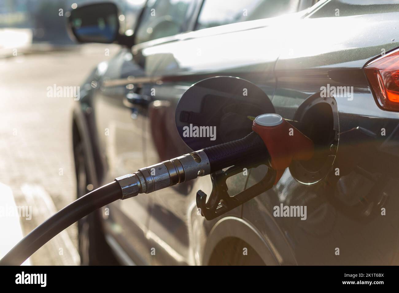 Fuel nozzle to refill fuel in car at gas station. Red fuel dispenser on ...