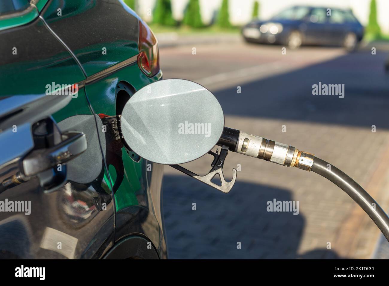Fuel nozzle to refill fuel in car at gas station. Red fuel dispenser on ...