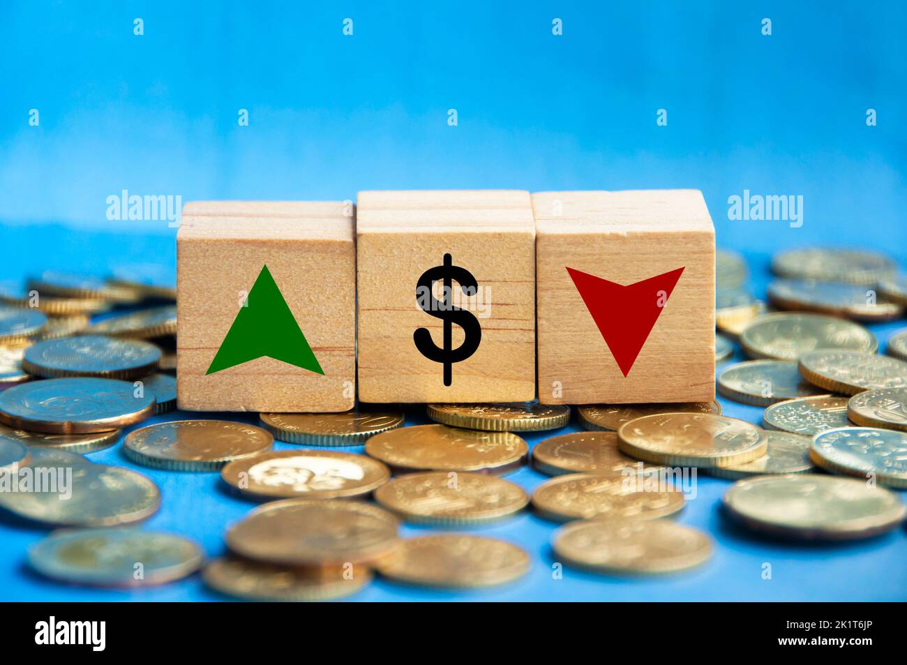 Wooden blocks with dollar icon and symbol arrow up and down. Business ...