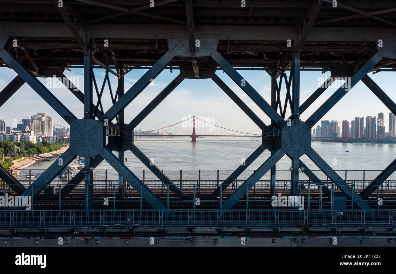 The foundation of a bridge with a view of another red bridge over the ...