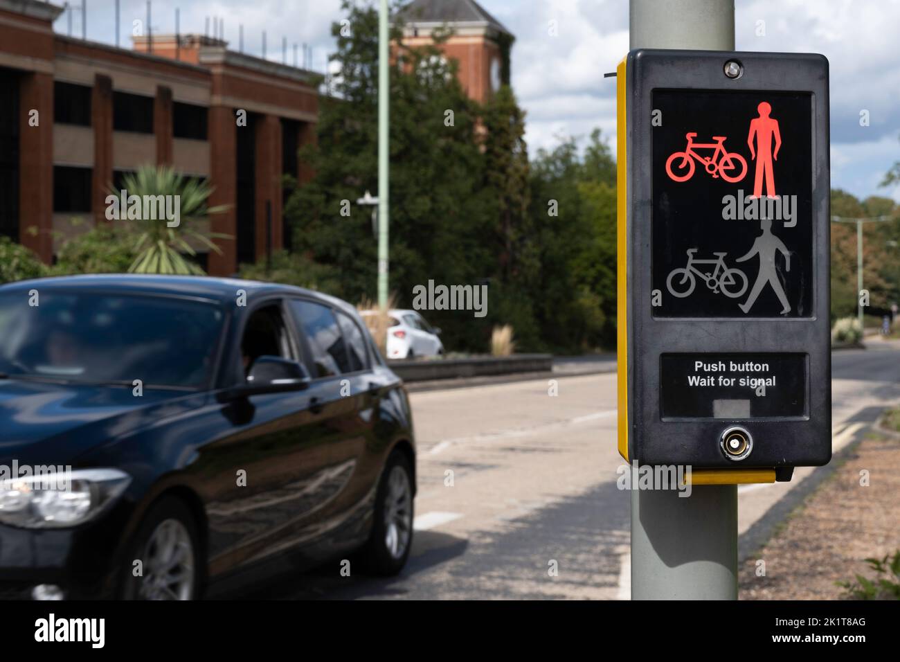 Crosswalk button for pedestrians and cyclists with light warning in the ...