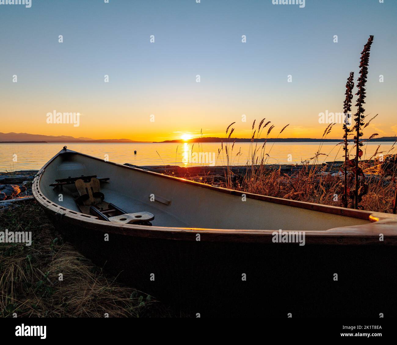 Sunset over canoe; Puget Sound; Whidbey Island; Washington; USA Stock ...