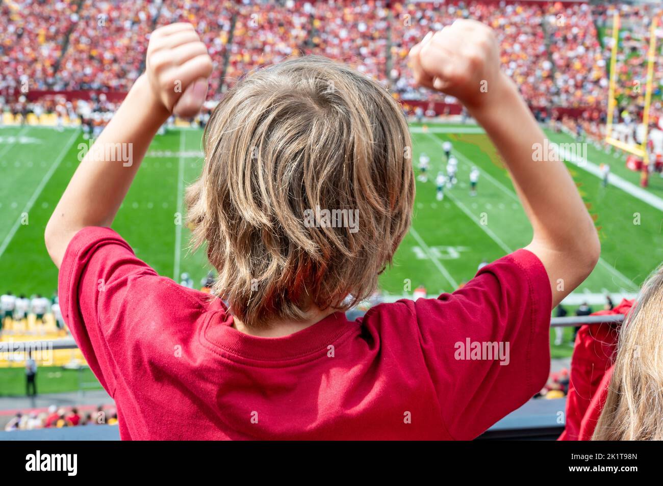 Caucasian boy celebrating with raised arms at a football game Stock ...