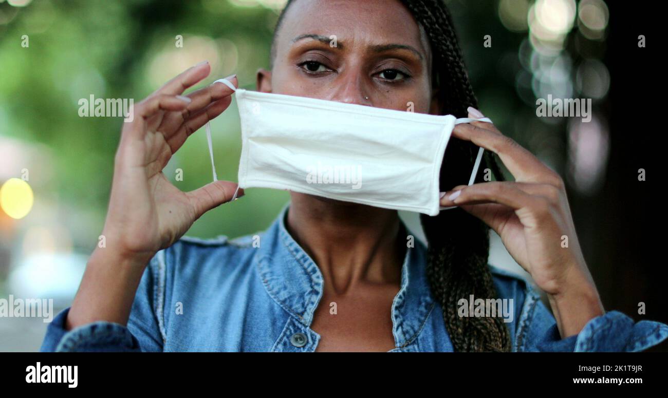 African woman putting face mask hi-res stock photography and images - Alamy