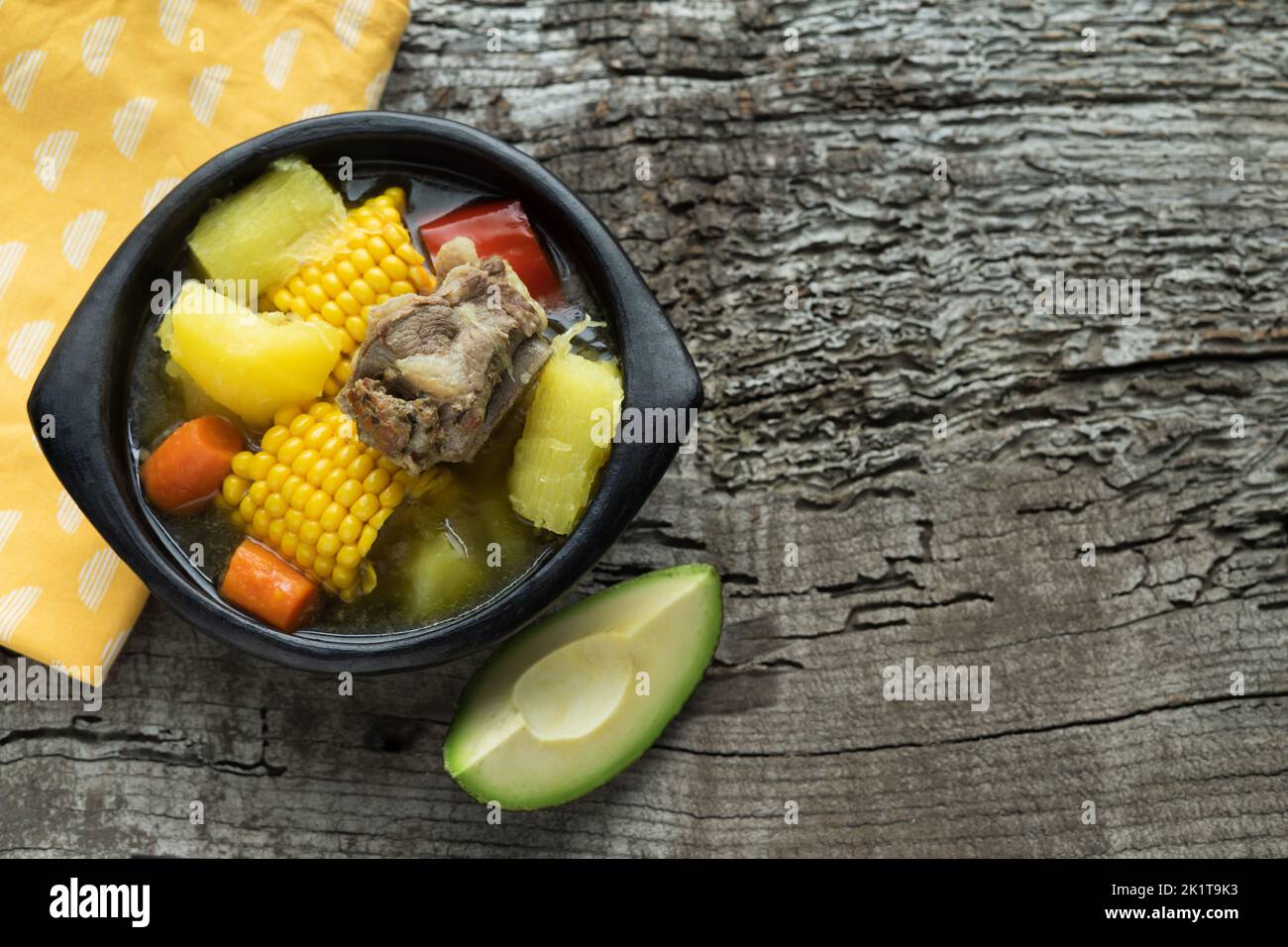 Sancocho, typical Colombian food in a black ceramic bowl on a rustic ...