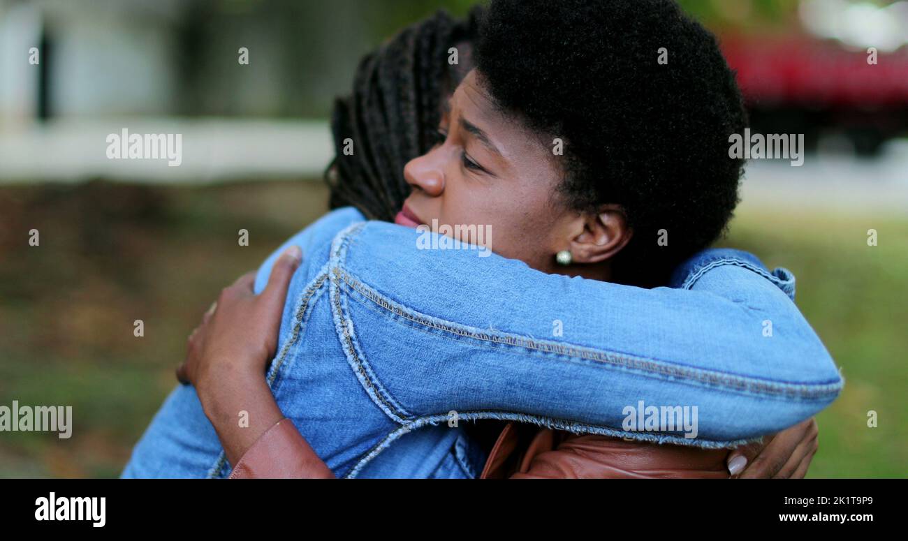 Depressed African woman, friend helping compassionate hug Stock Photo ...