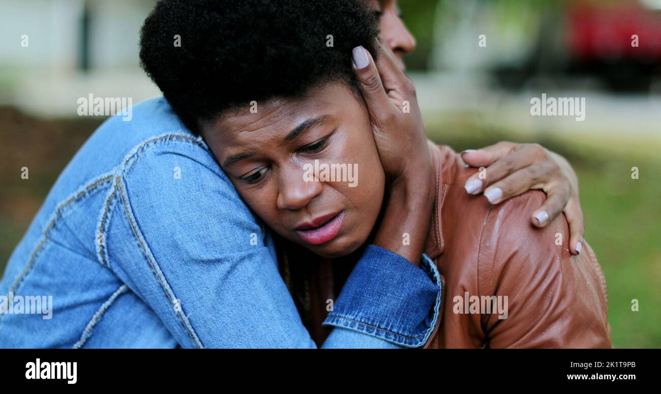 Depressed African woman, friend helping compassionate hug Stock Photo ...