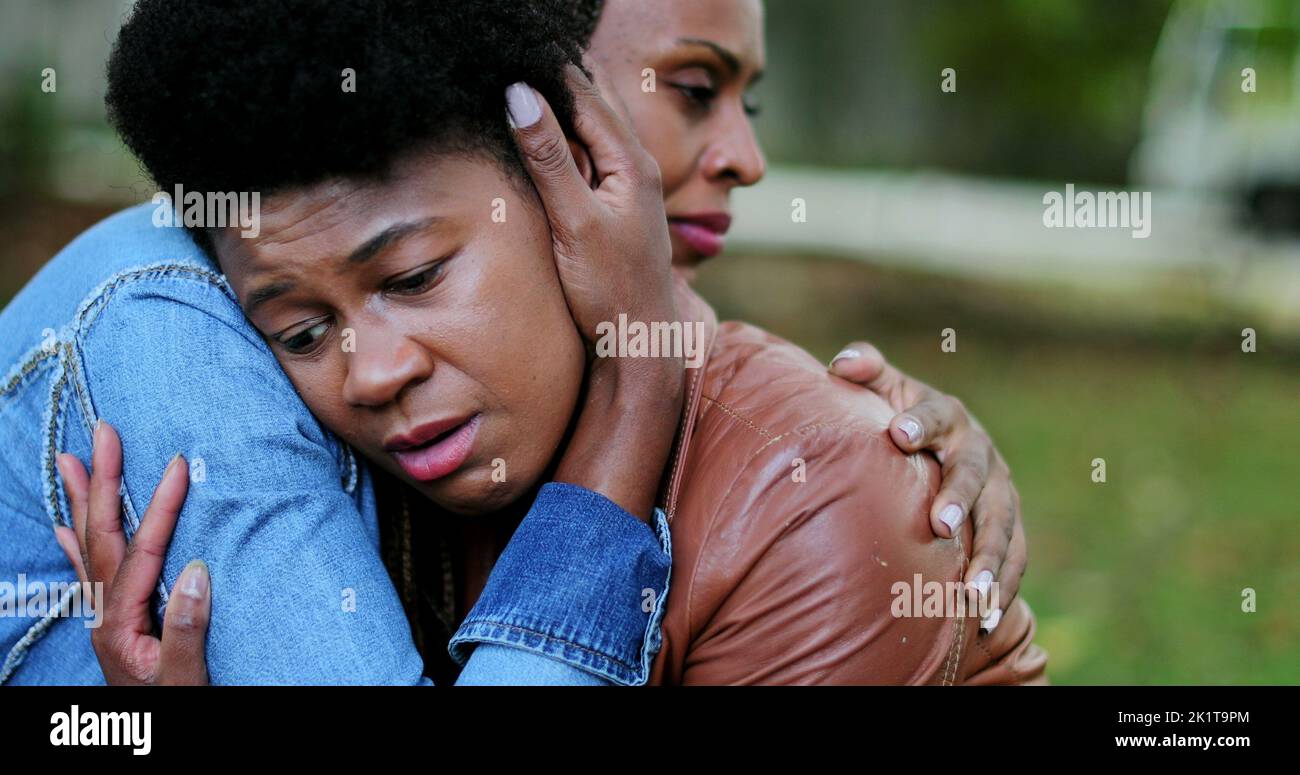 Depressed African woman, friend helping compassionate hug Stock Photo ...