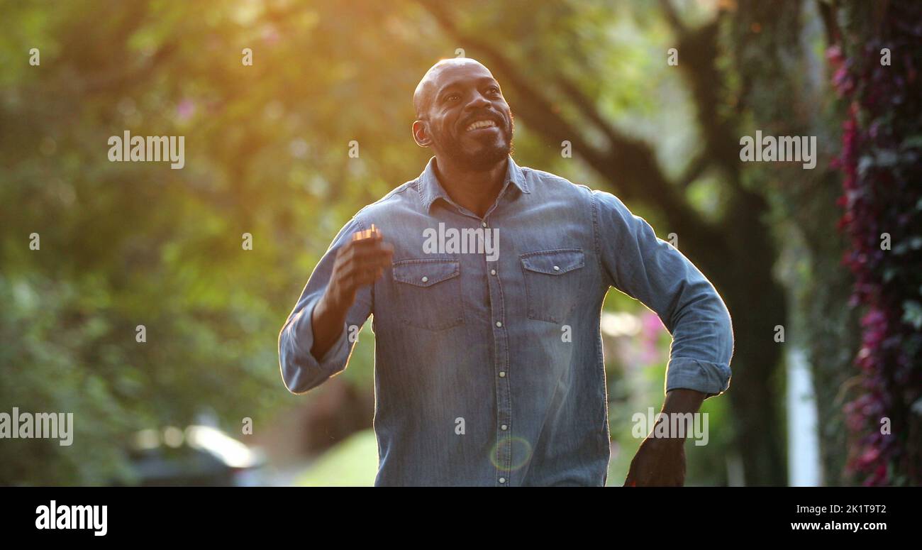 Happy African man dancing in street celebrating success Stock Photo - Alamy