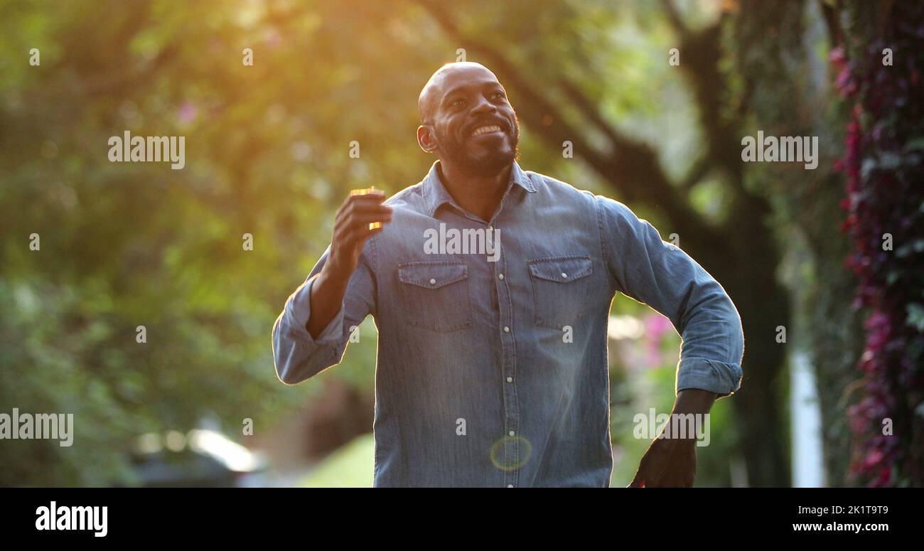 Happy African man dancing in street celebrating success Stock Photo - Alamy