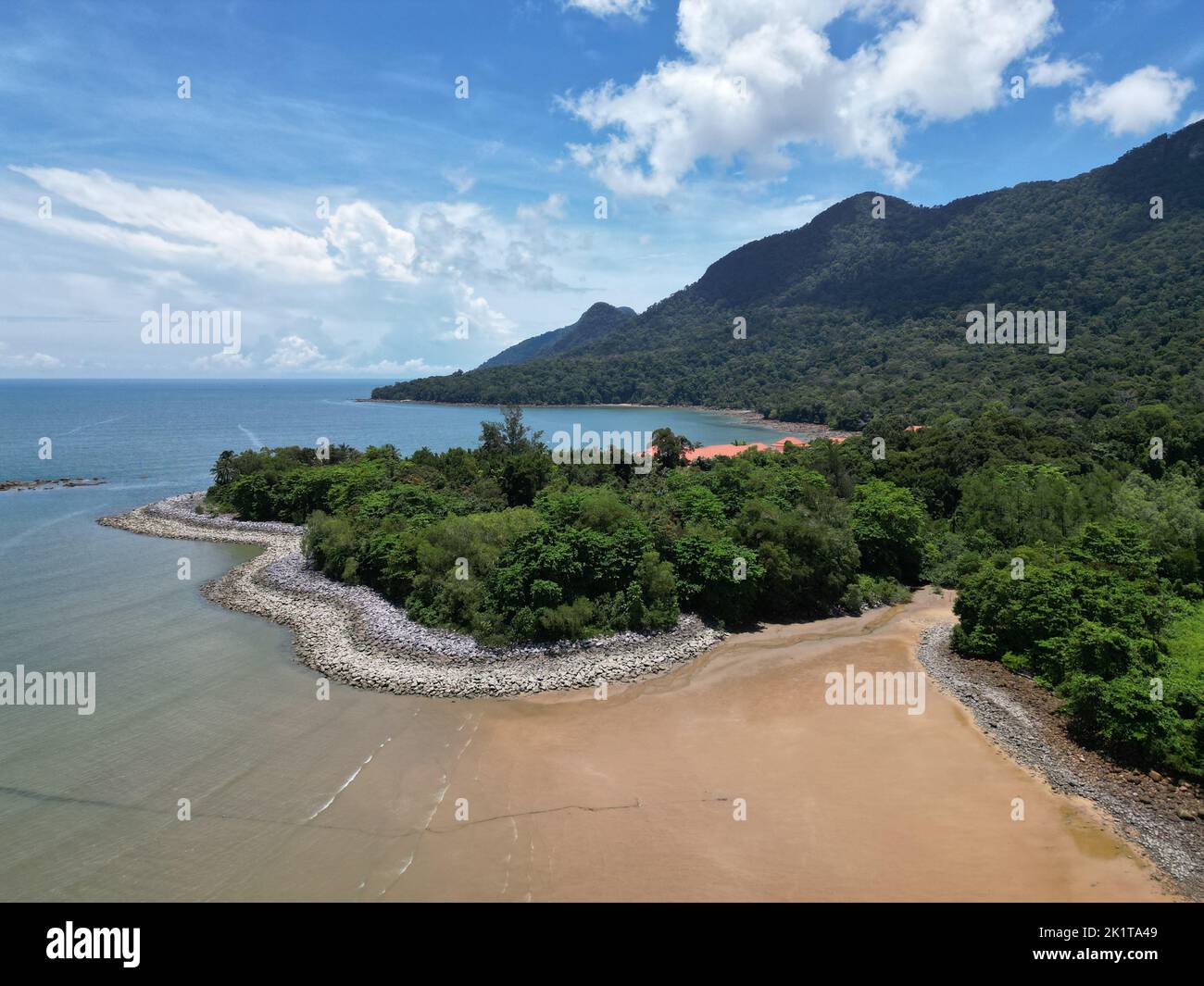An aerial view of the ocean surrounded by beautiful greenery and ...