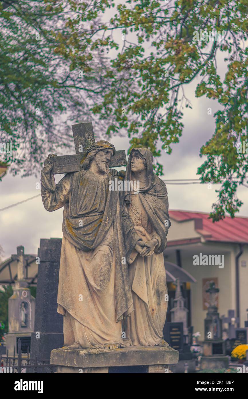 christian religious statue from rock in the cemetery Stock Photo - Alamy
