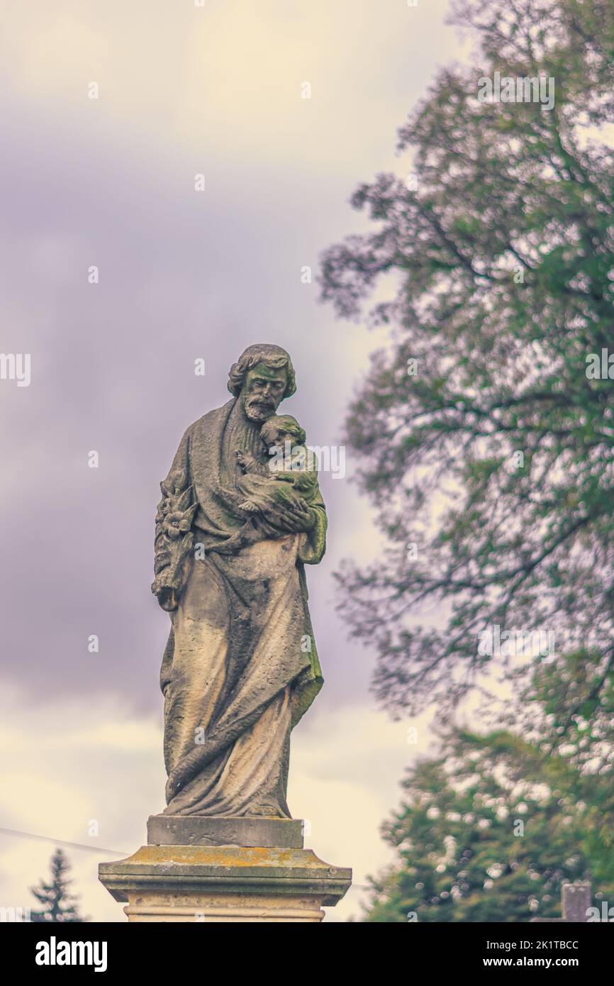 christian religious statue from rock in the cemetery Stock Photo - Alamy