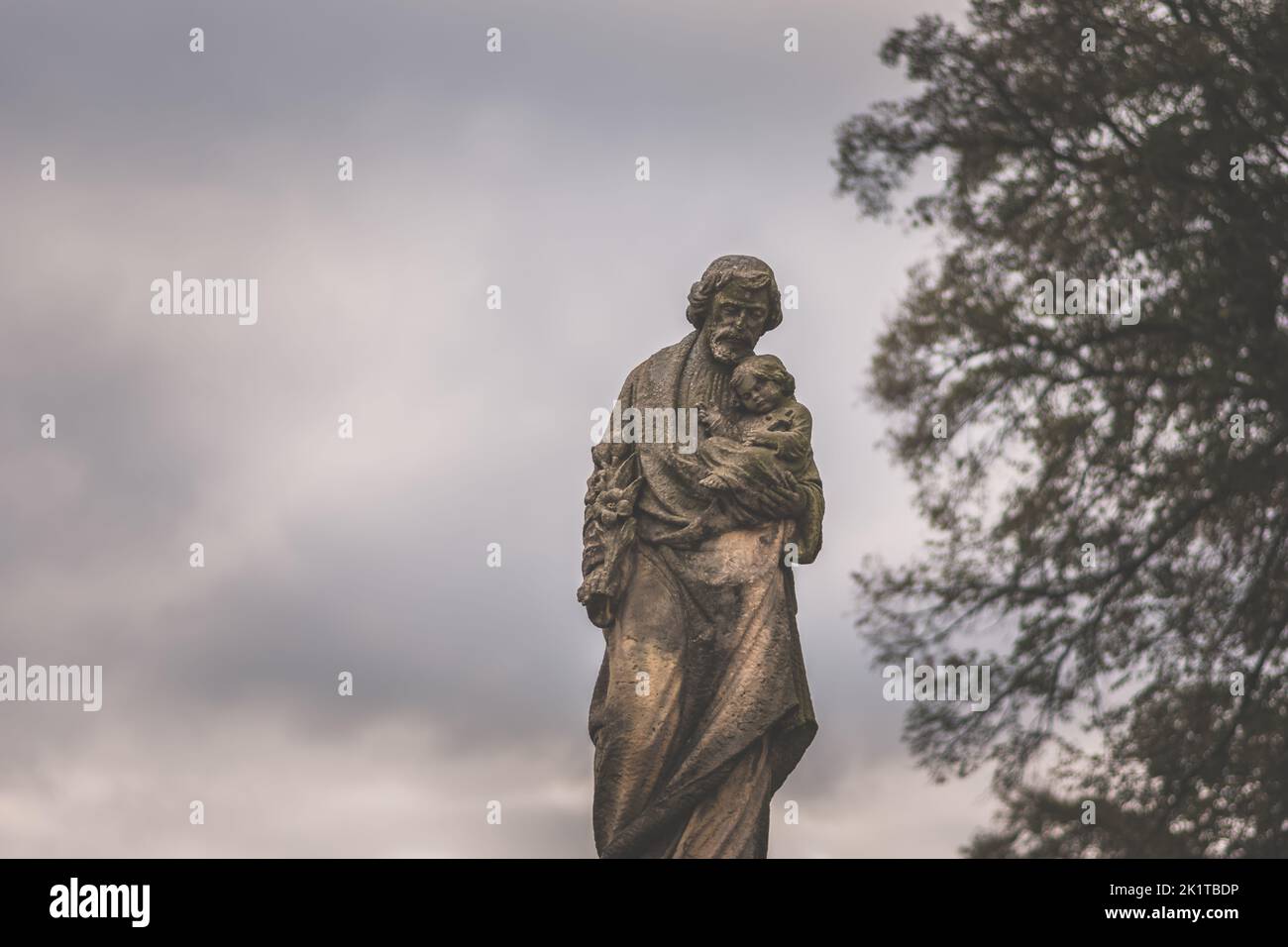 christian religious statue from rock in the cemetery Stock Photo - Alamy