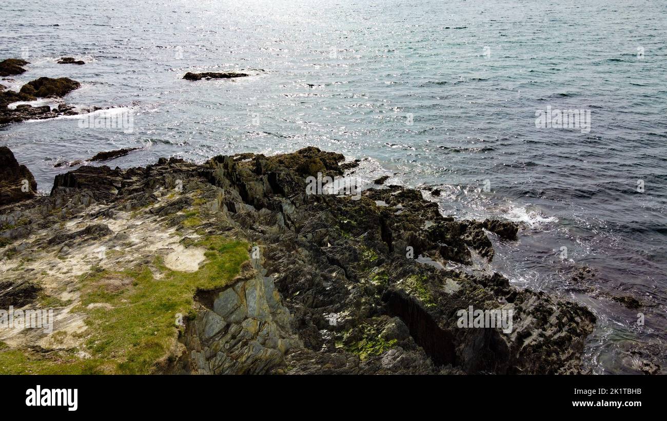 Stone cape of the coast of Ireland, top view. Rocky seashore in sunny ...