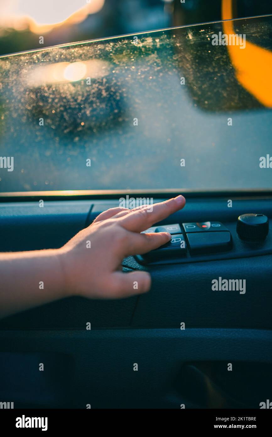 A child's fingers opening a window of a car Stock Photo - Alamy