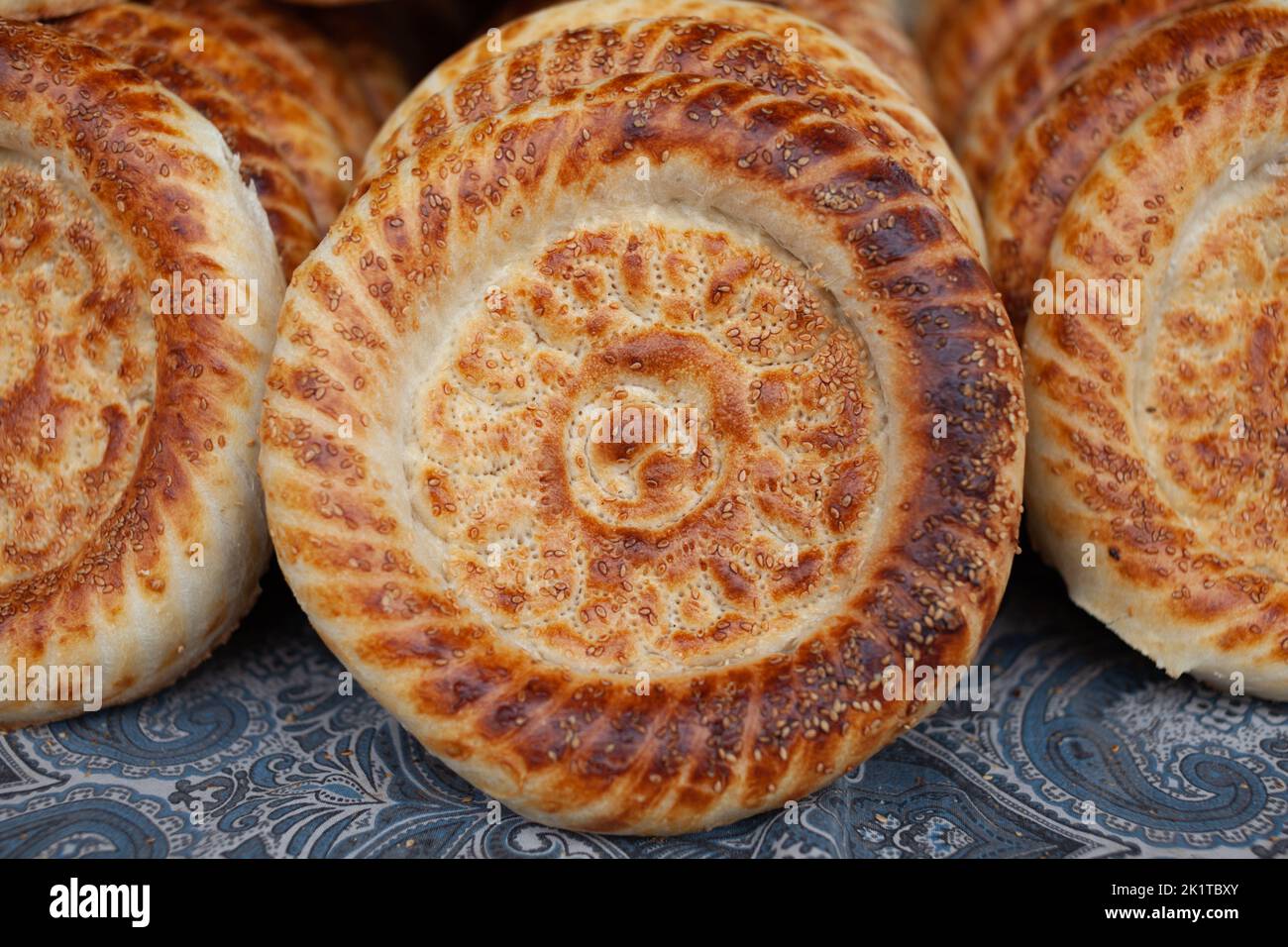Typical traditional flatbread with crunchy crust with sesam just baked ...