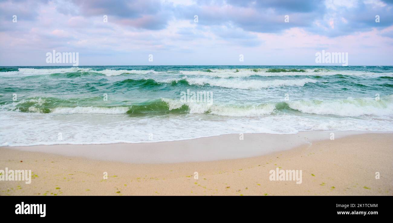 sandy beach before the storm. evening scenery with heavy clouds in ...