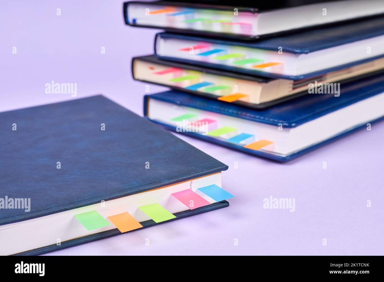Close-up of a stack of office notepads with colorful sticky page ...
