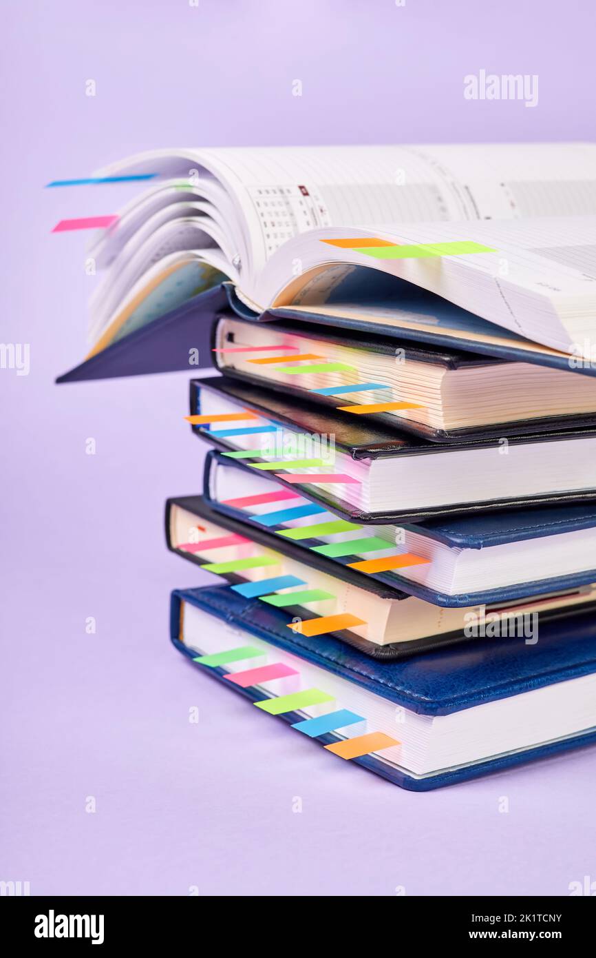 Close-up of a stack of office notepads with colorful sticky page ...